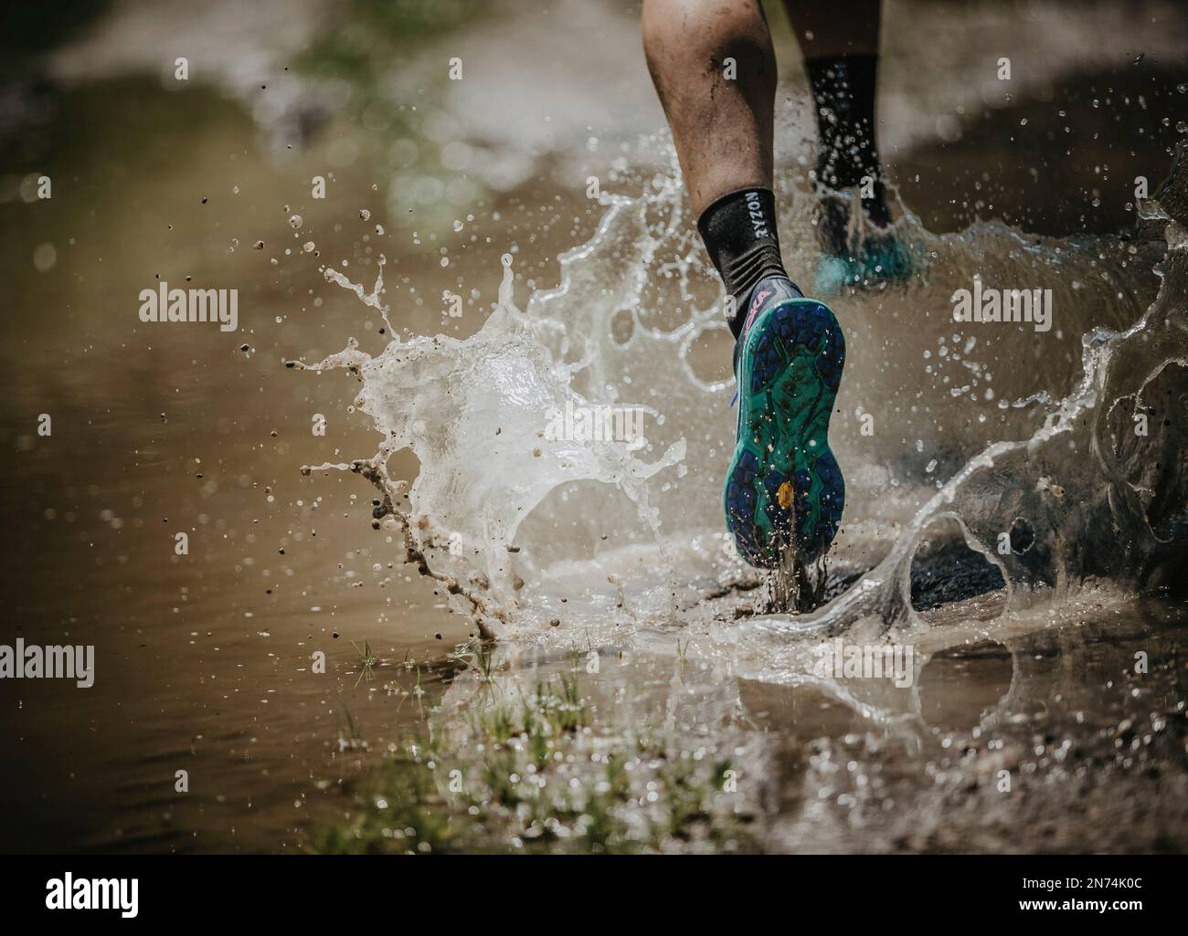 Professional triathlete on a trail running training lap in the forest ...