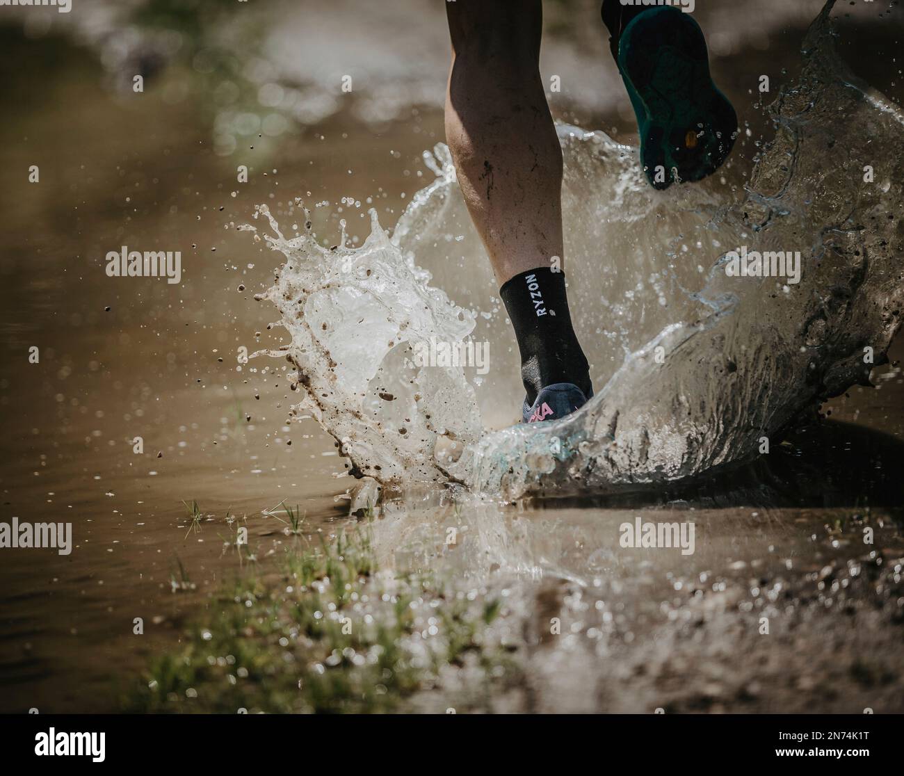 Professional triathlete on a trail running training lap in the forest ...