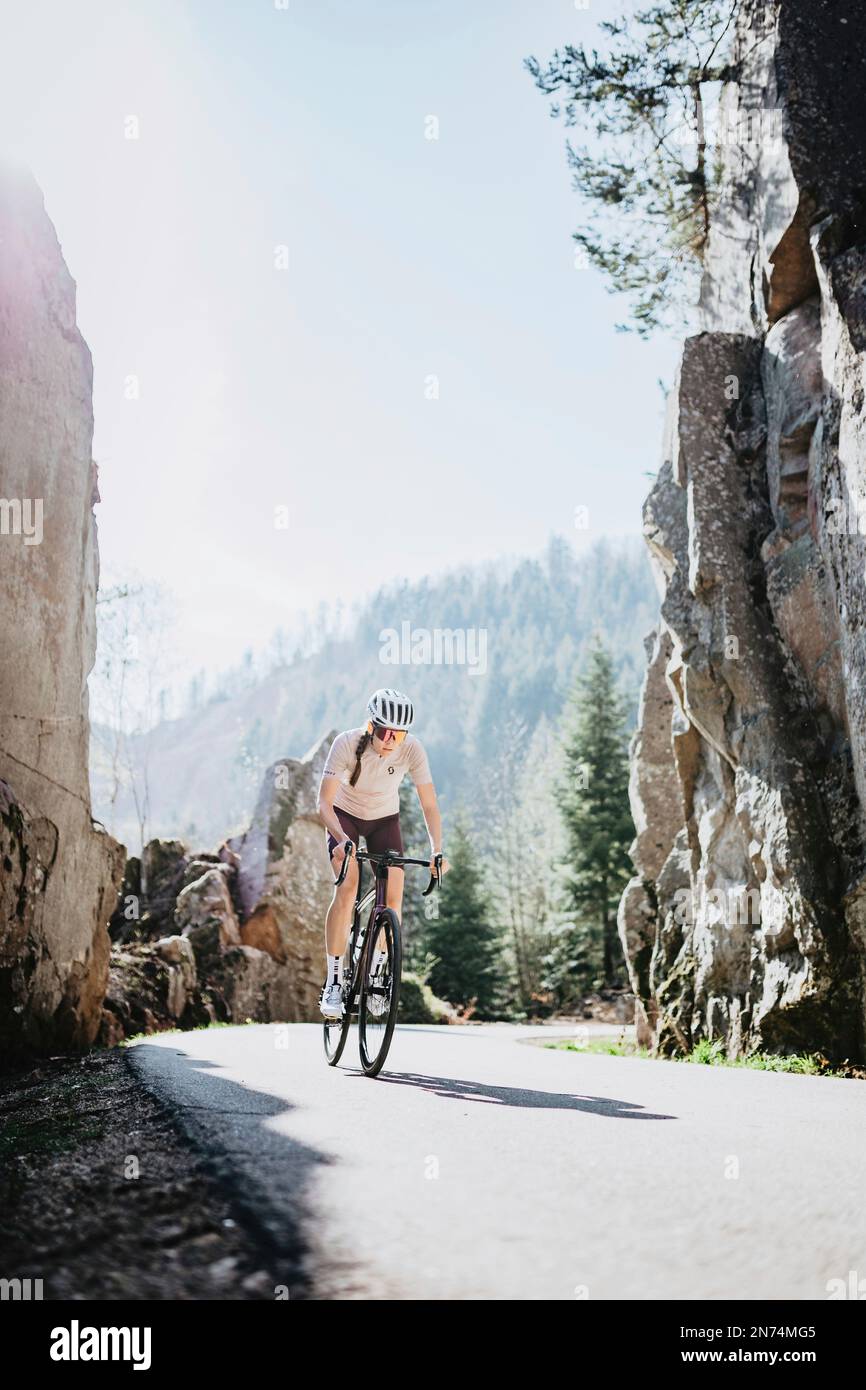 Professional triathlete with her road bike on a training lap in Black ...