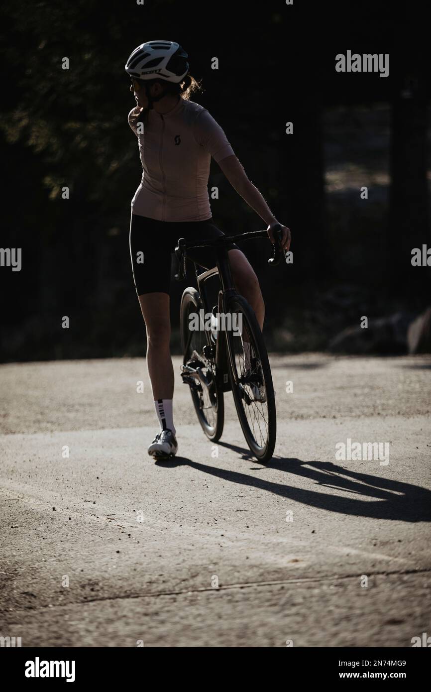 Professional triathlete with her road bike on a training lap in Black ...