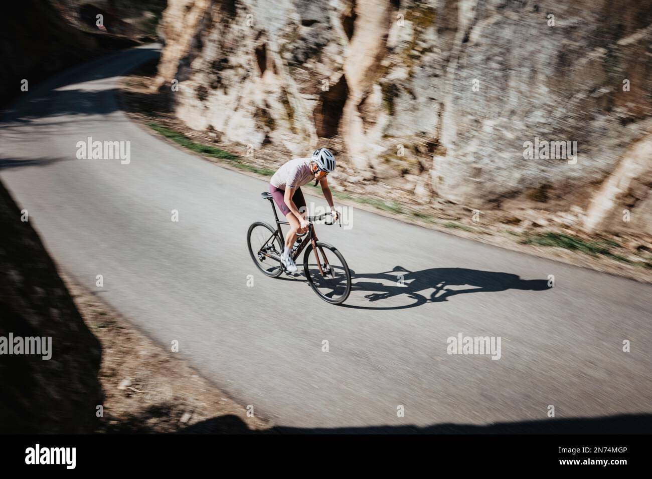 Professional triathlete with her road bike on a training lap in Black ...