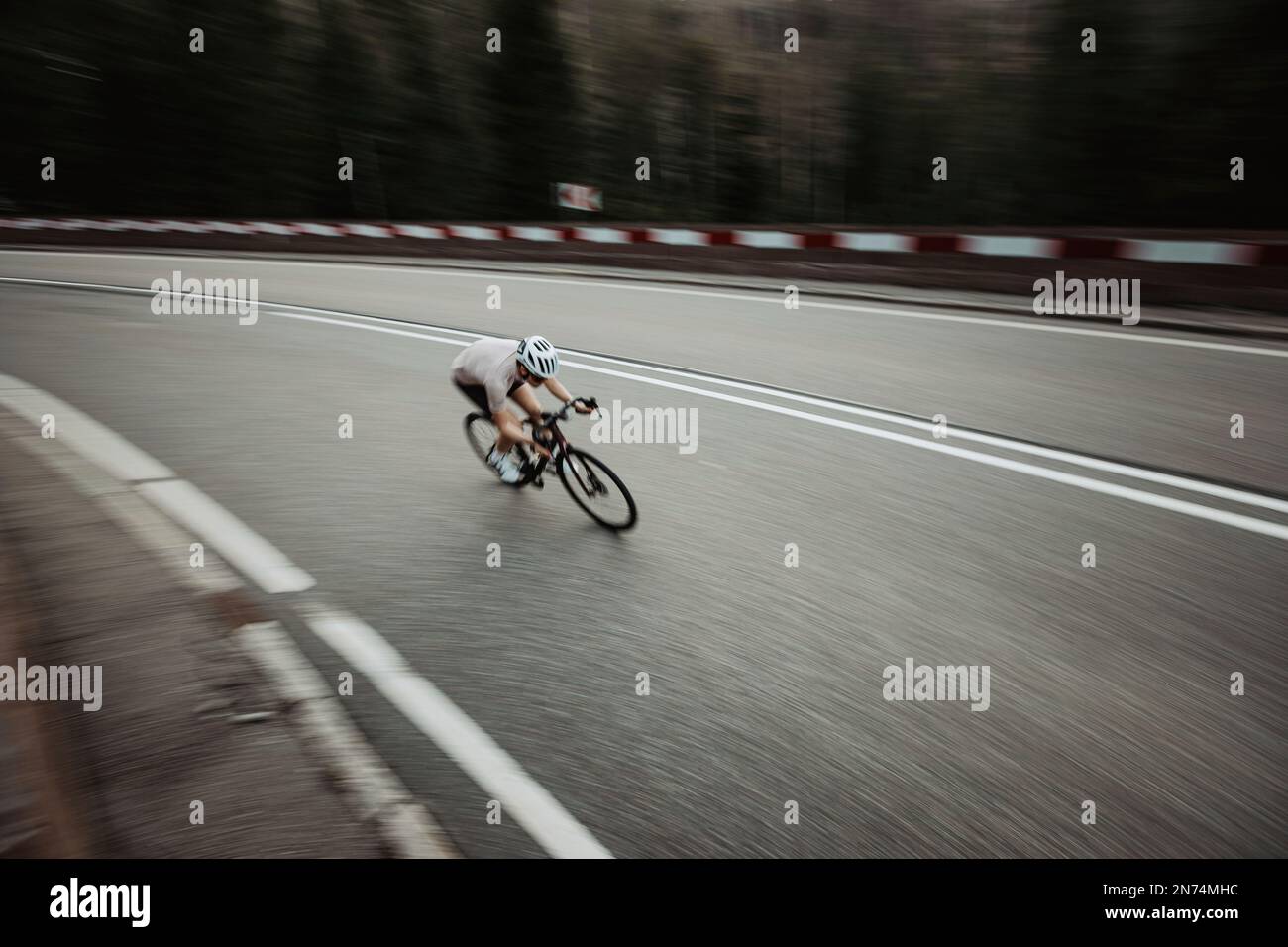 Professional triathlete with her racing bike on a training lap in the ...