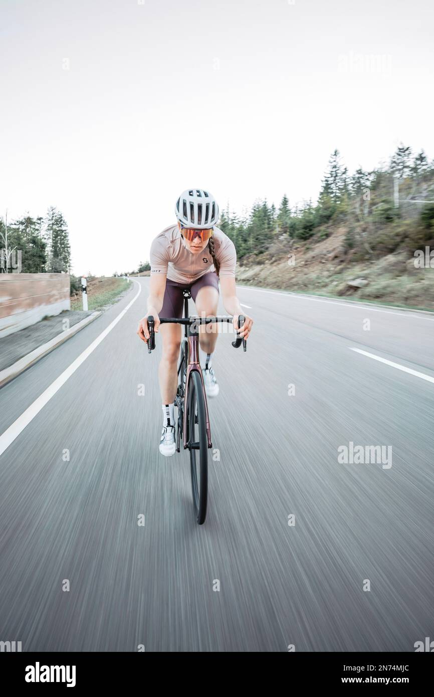 Professional triathlete with her road bike on a training lap in Black ...