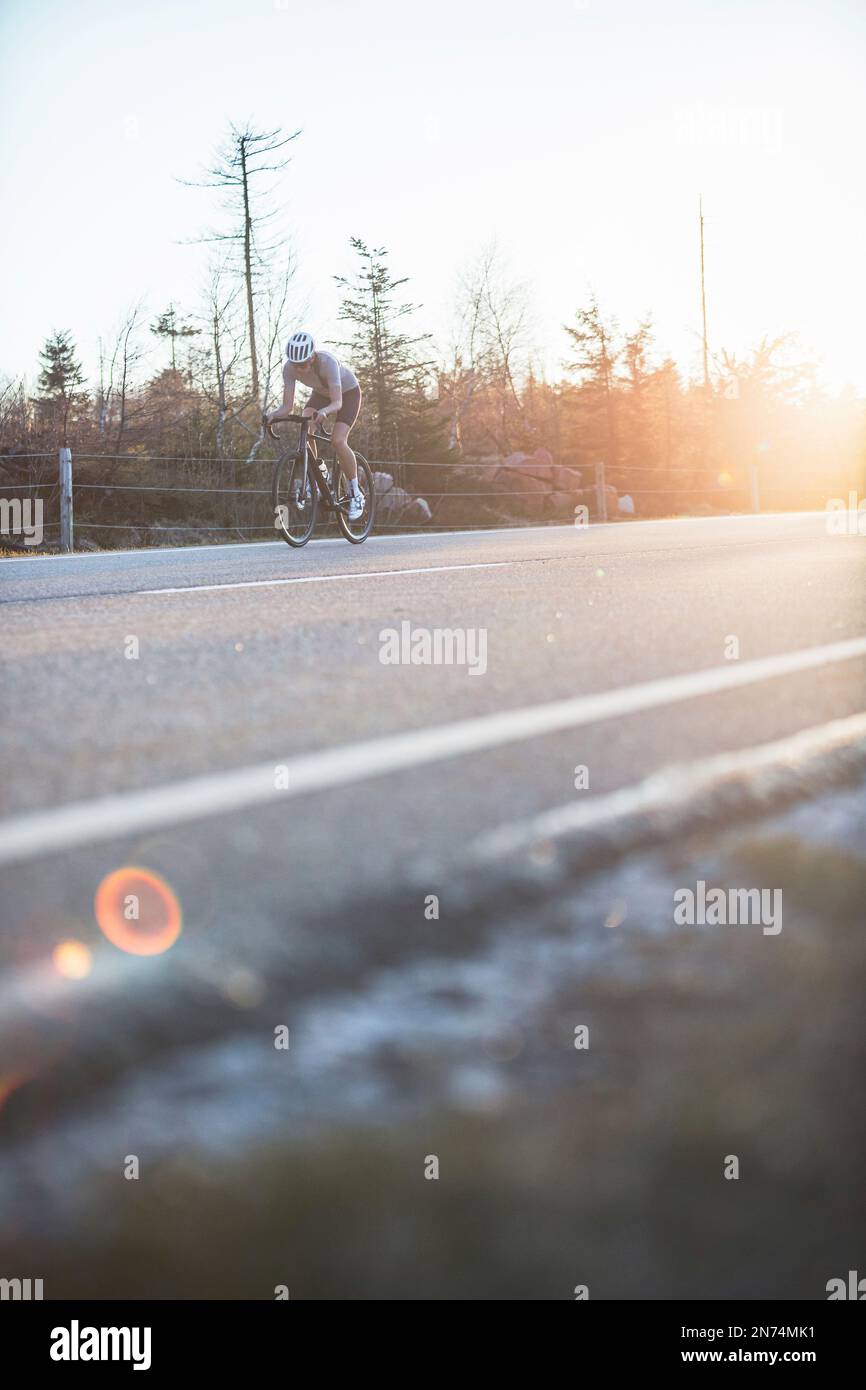 Professional triathlete with her road bike on a training lap in Black ...