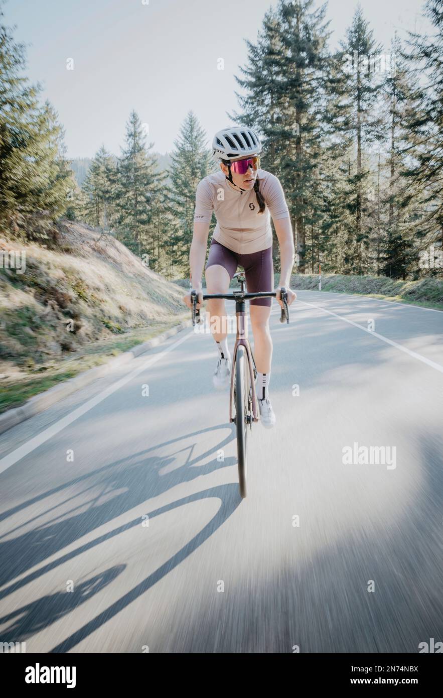 Professional triathlete with her road bike on a training lap in Black ...