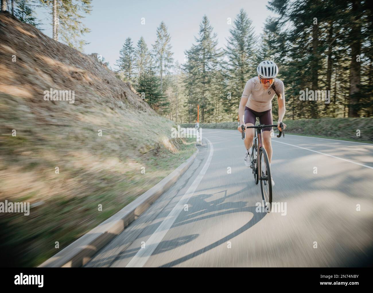 Professional triathlete with her road bike on a training lap in Black ...