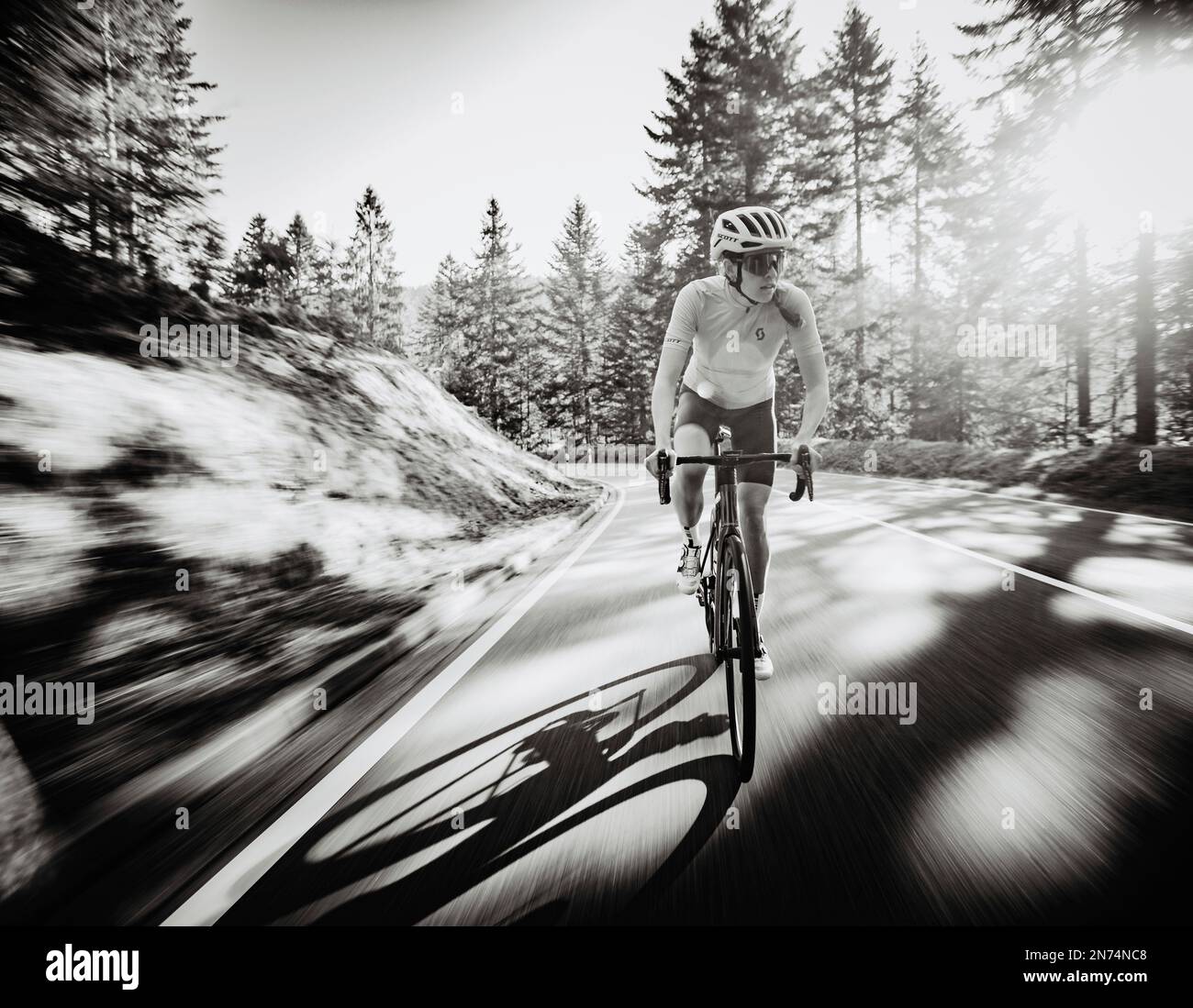 Professional triathlete with her road bike on a training lap in Black ...