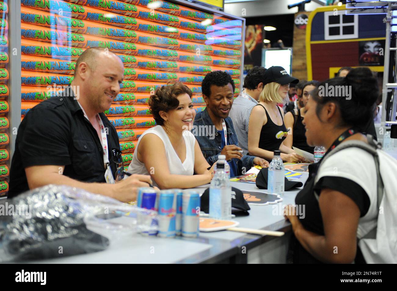 From left, Will Sasso, Justina Machado and Phil Lamarr sign autographs ...