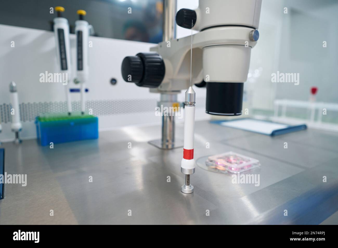 Microscope and stripper on table for preparatory work with biomaterial ...