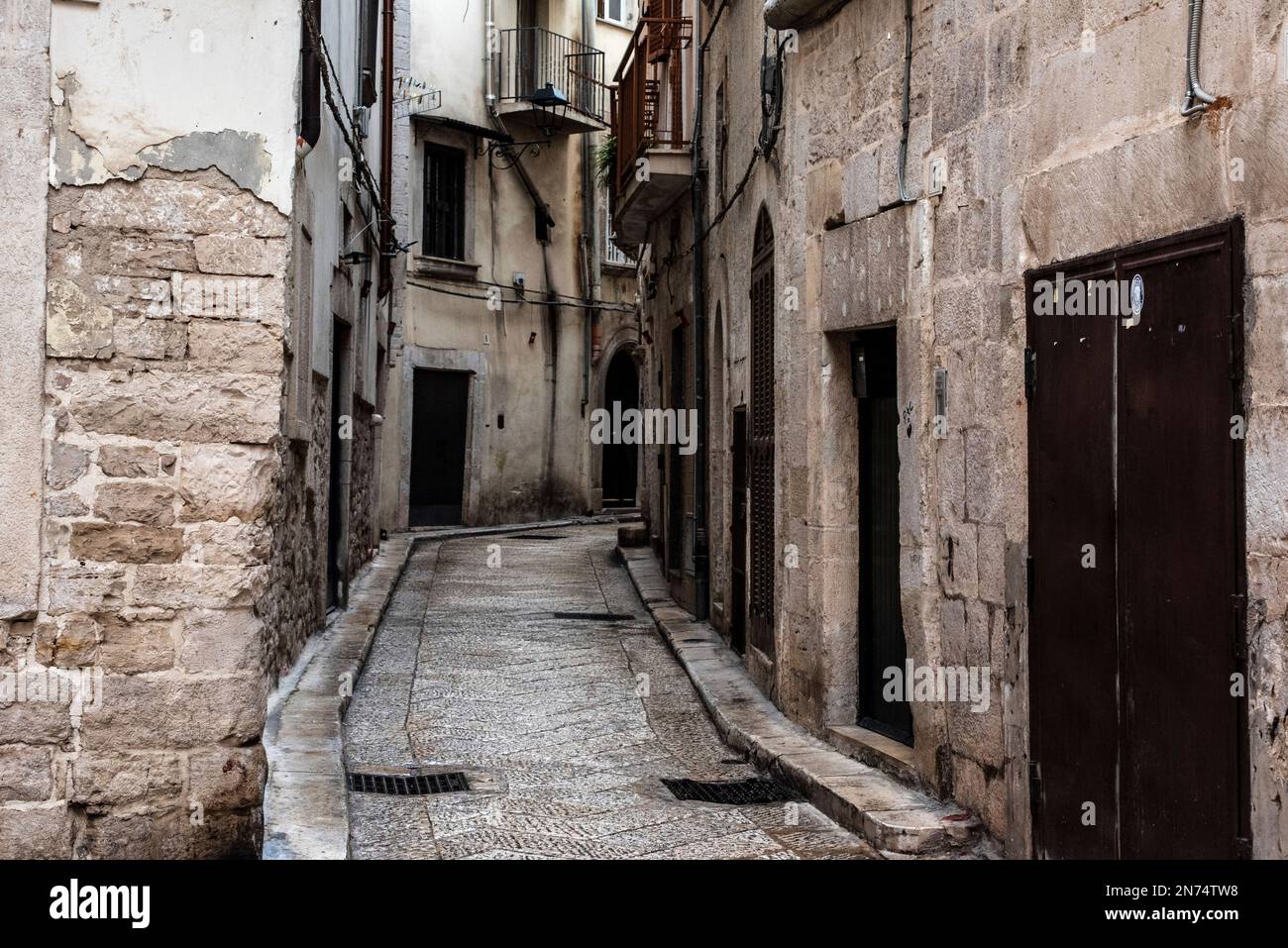 Old ancient typical alleyway in the Italian town of Trani, Southern ...