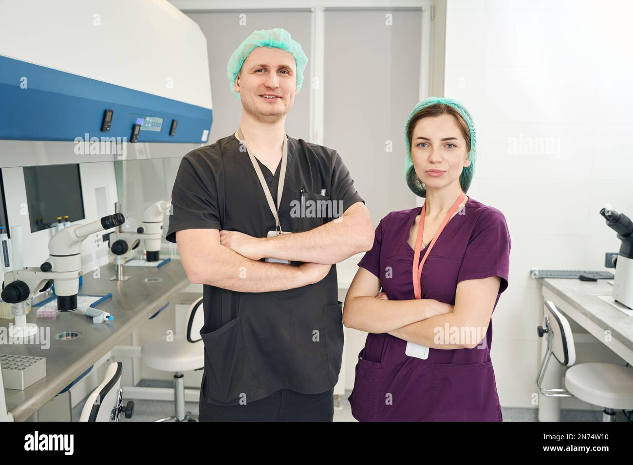 Laboratory staff stand indoors at workplace, they are in overalls Stock ...