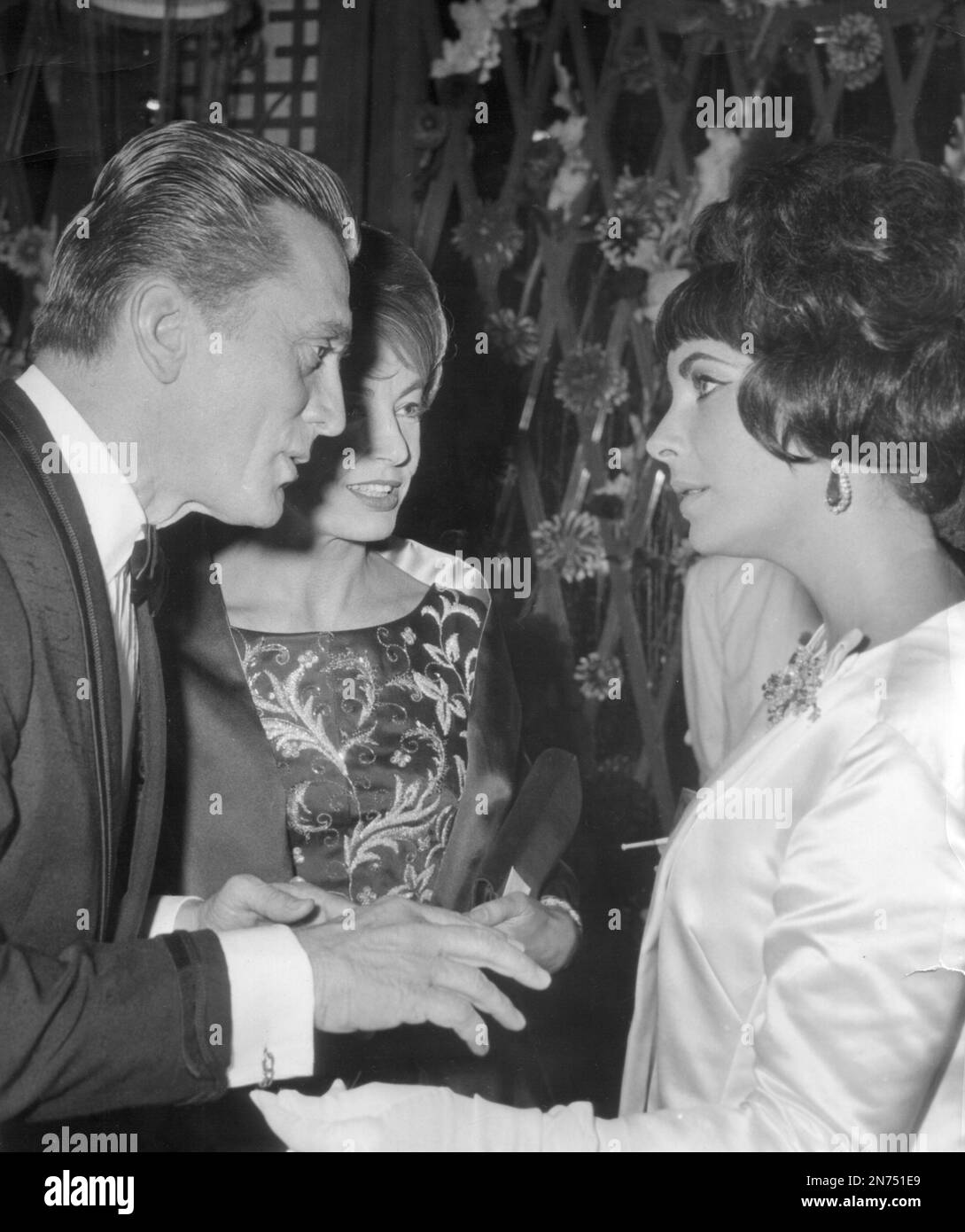 British born actress Elizabeth Taylor talks with American actor Kirk ...