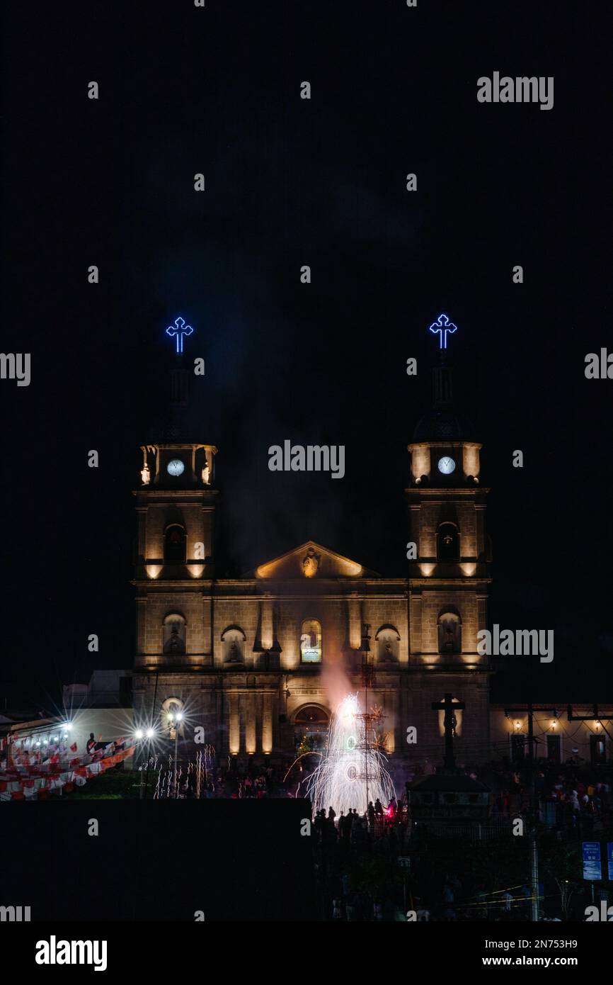 A vertical shot of fireworks in front of church during city's holidays ...