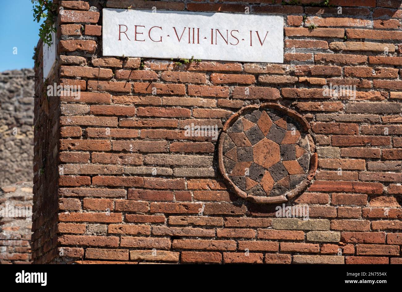 Sign with the street's name in ancient Pompeii and a fresco decoration ...