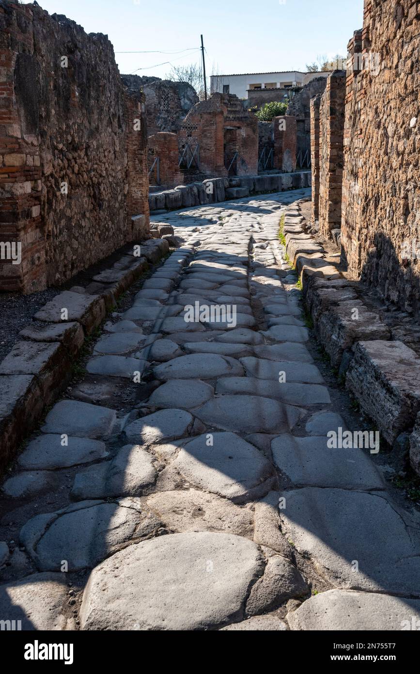 A beautiful typical cobbled street in the ancient city of Pompeii ...