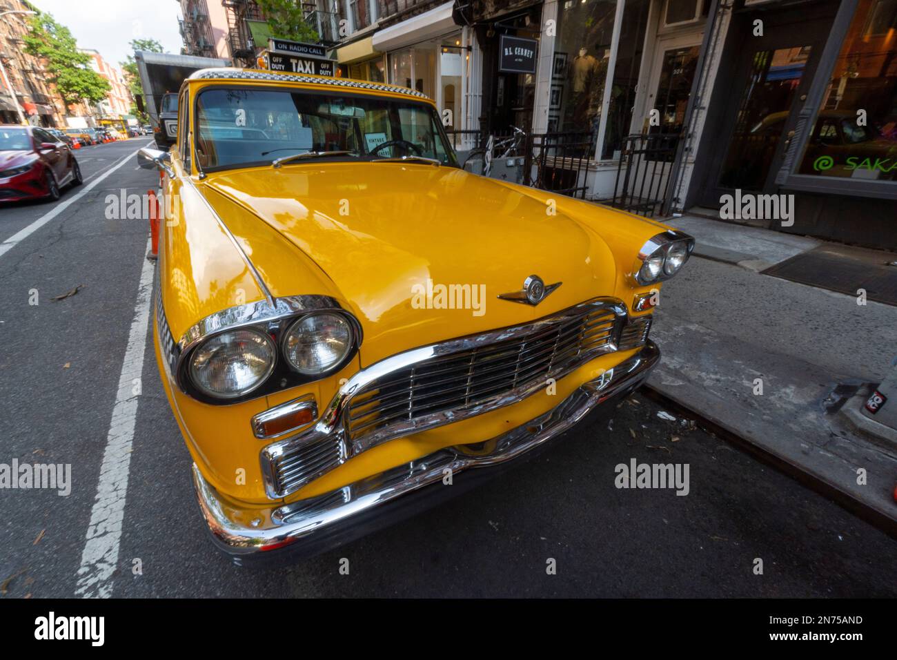 Classic Yellow Taxies park on the street at East Village in New York ...