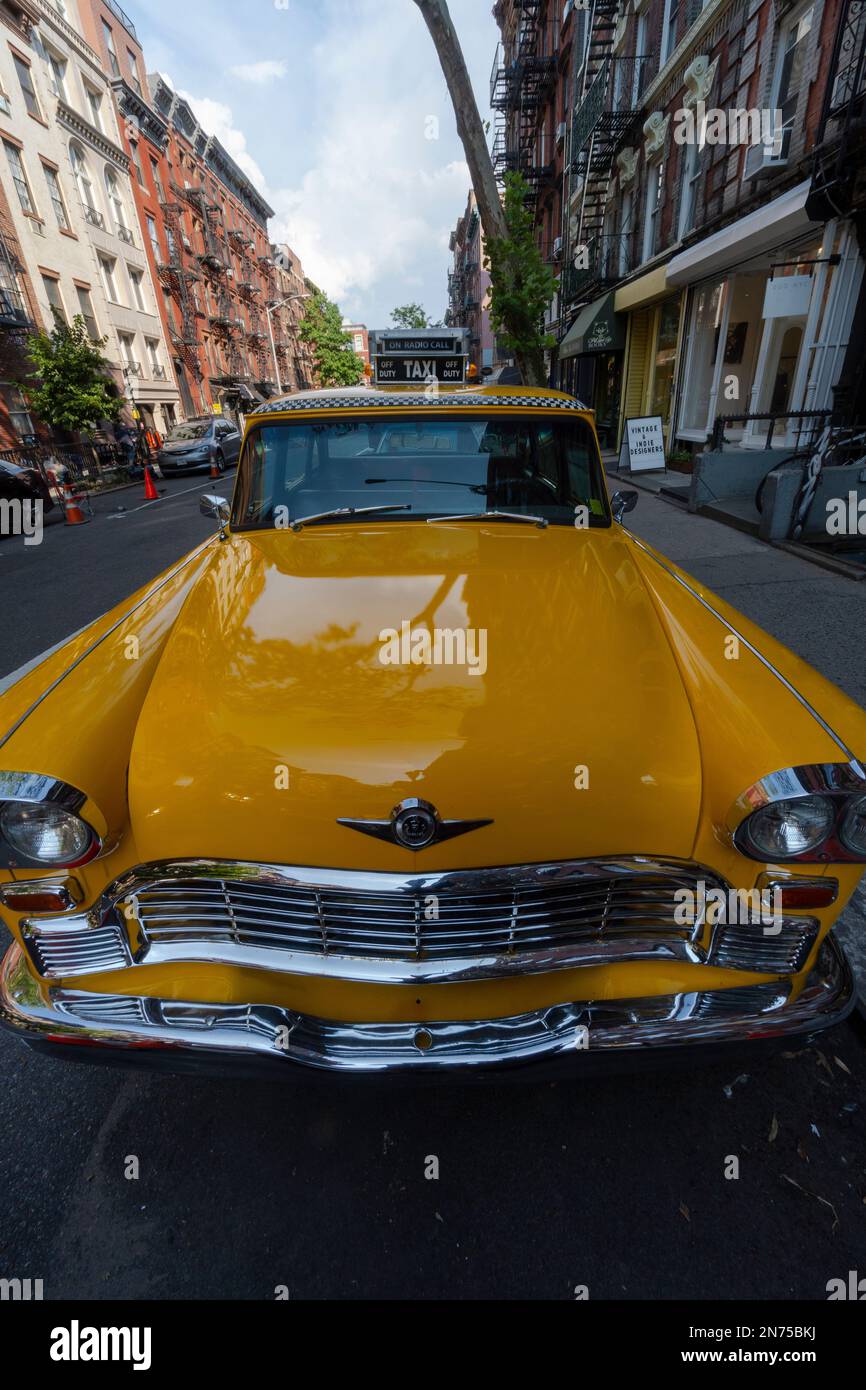 Classic Yellow Taxies park on the street at East Village in New York ...