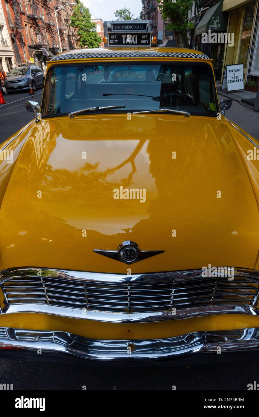 Classic Yellow Taxies park on the street at East Village in New York ...