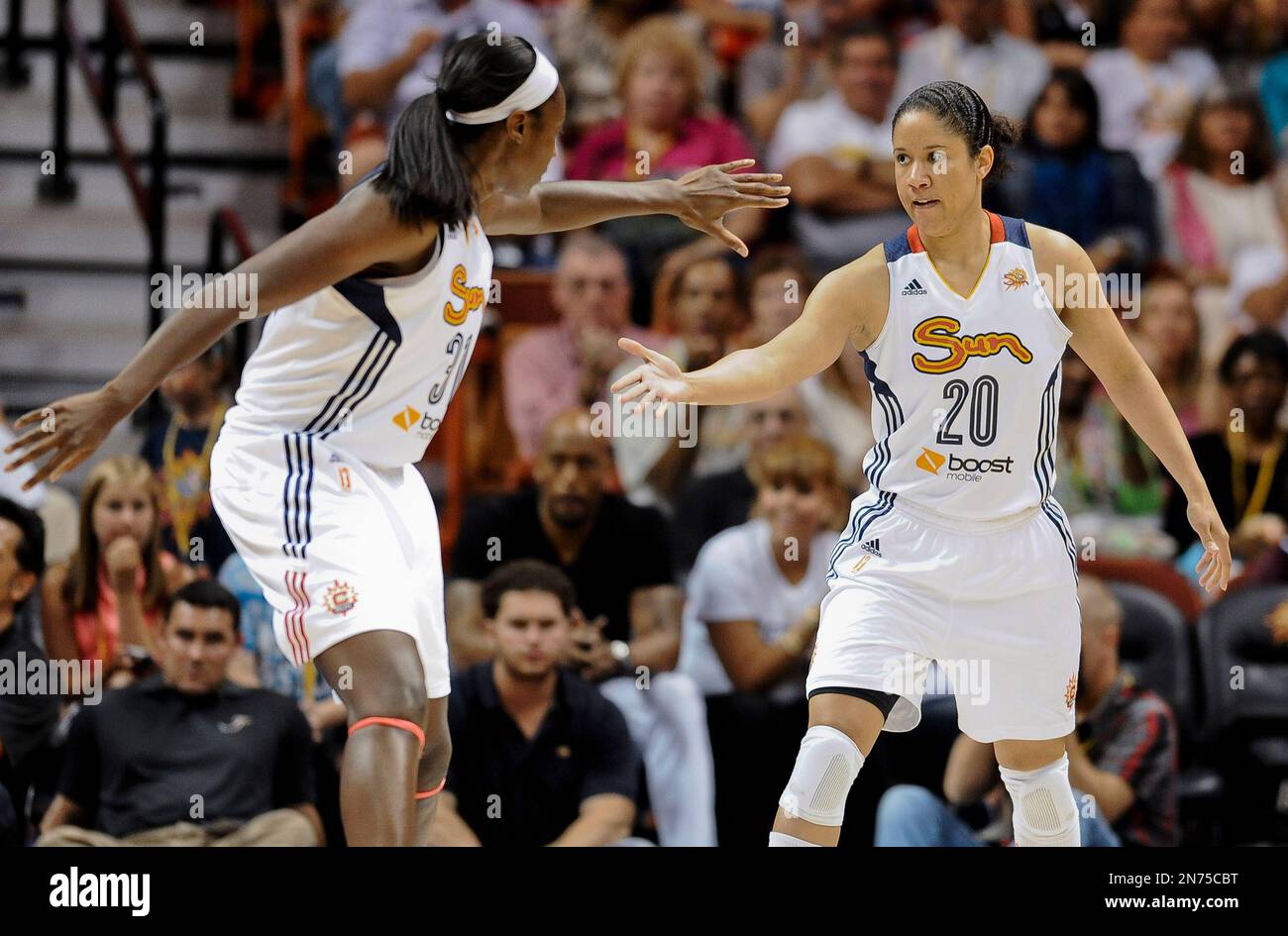 Connecticut Sun's Tina Charles, left, and Kara Lawson react during the ...