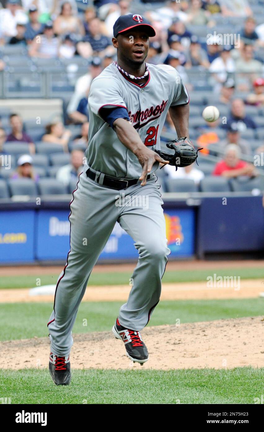 Minnesota Twins pitcher Samuel Deduno flips the ball to first to get ...
