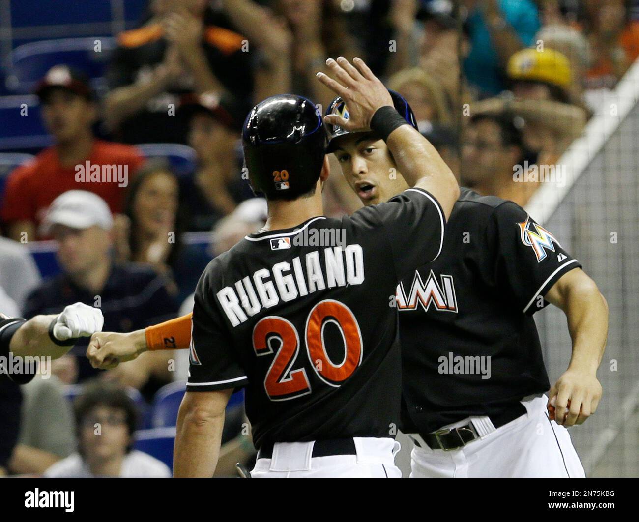 Miami Marlins' Giancarlo Stanton, background, and Justin Ruggiano (20 ...
