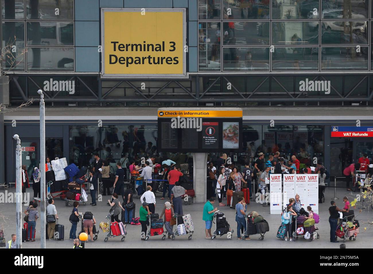 Passengers queue outside Terminal 3 at Heathrow Airport in London ...