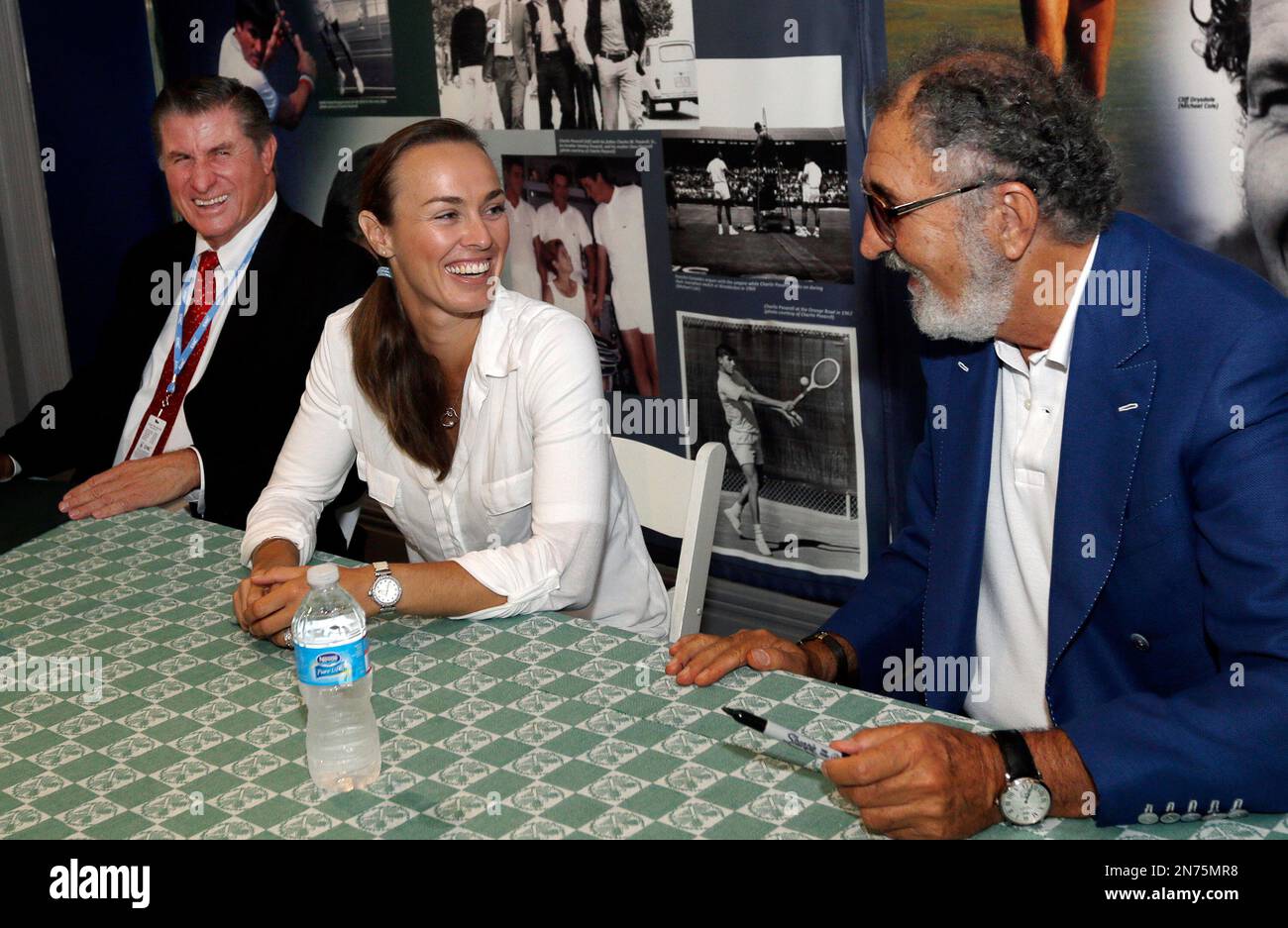 From left, Charlie Pasarell, Martina Hingis and Ion Tiriac laugh ...