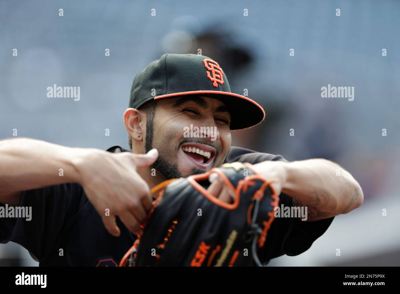 San Francisco Giants relief pitcher Sergio Romo jokes during batting ...