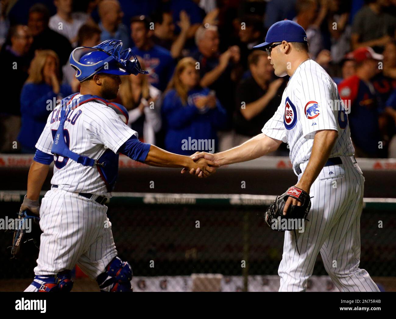 Chicago Cubs catcher Welington Castillo, left, and relief pitcher Kevin ...