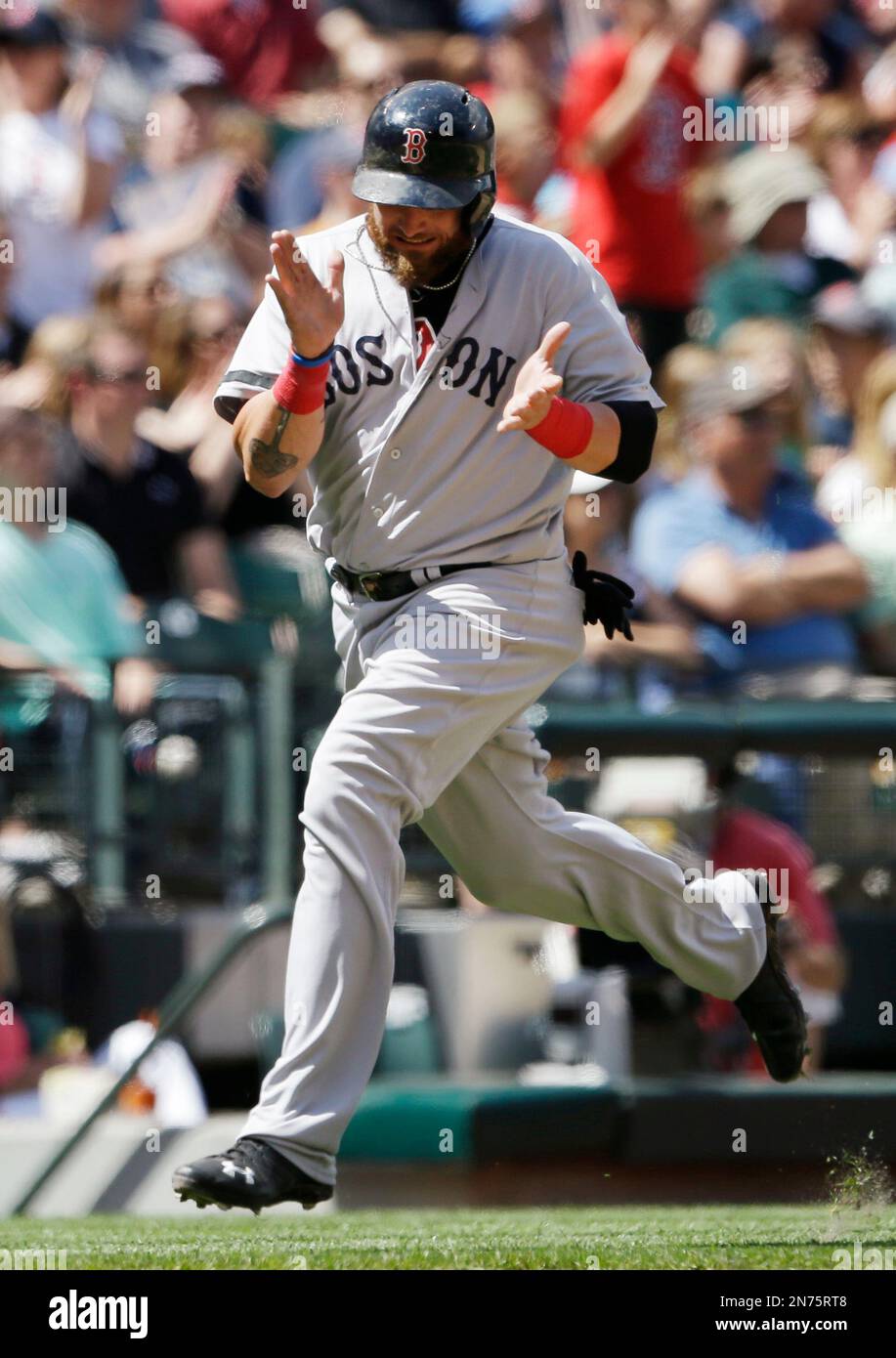 Boston Red Sox's Jonny Gomes claps his hands as he rounds third on his ...