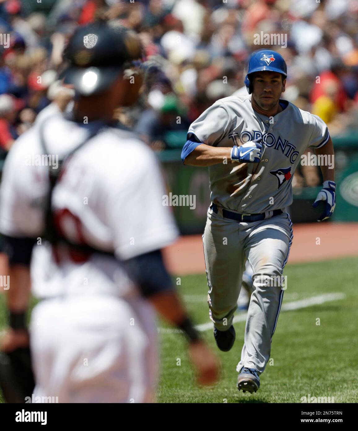 Toronto Blue Jays catcher Josh Thole, right, scores on a double by Jose ...