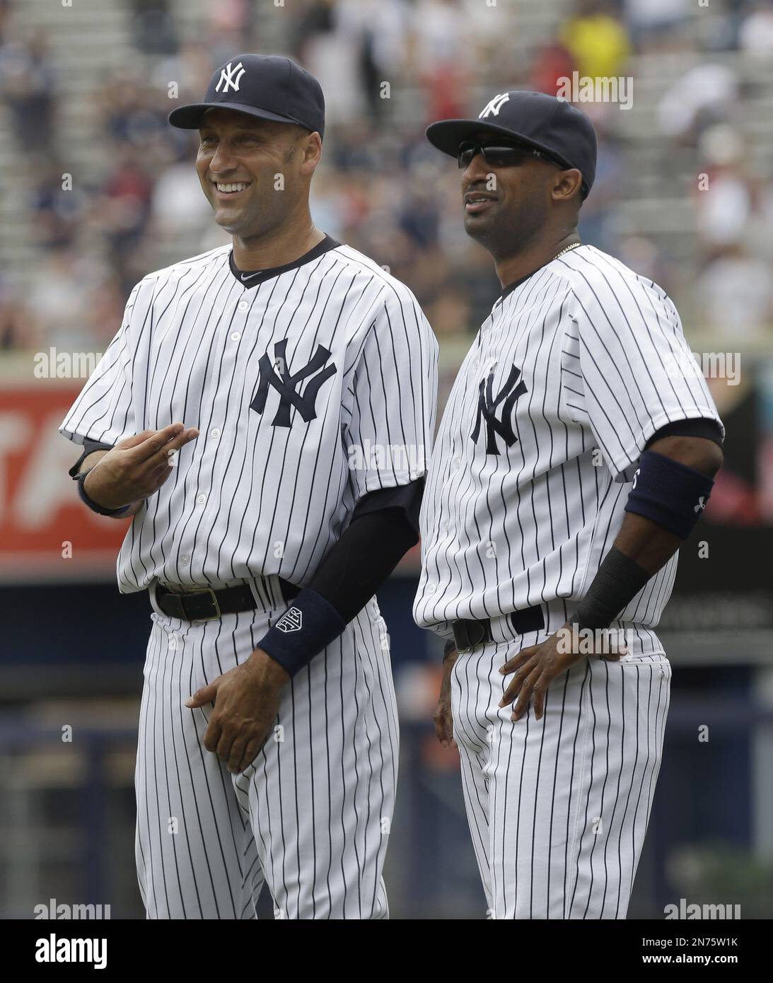 New York Yankees' Derek Jeter, left, and Eduardo Nunez warm-up before ...