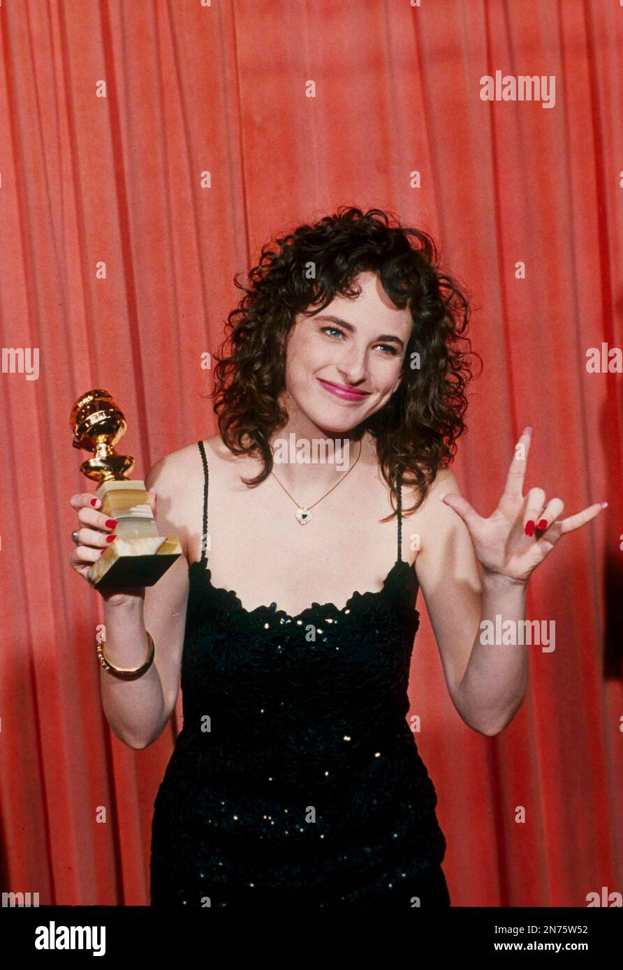 Marlee Matlin flashes the "I love you" sign while holding the Golden ...