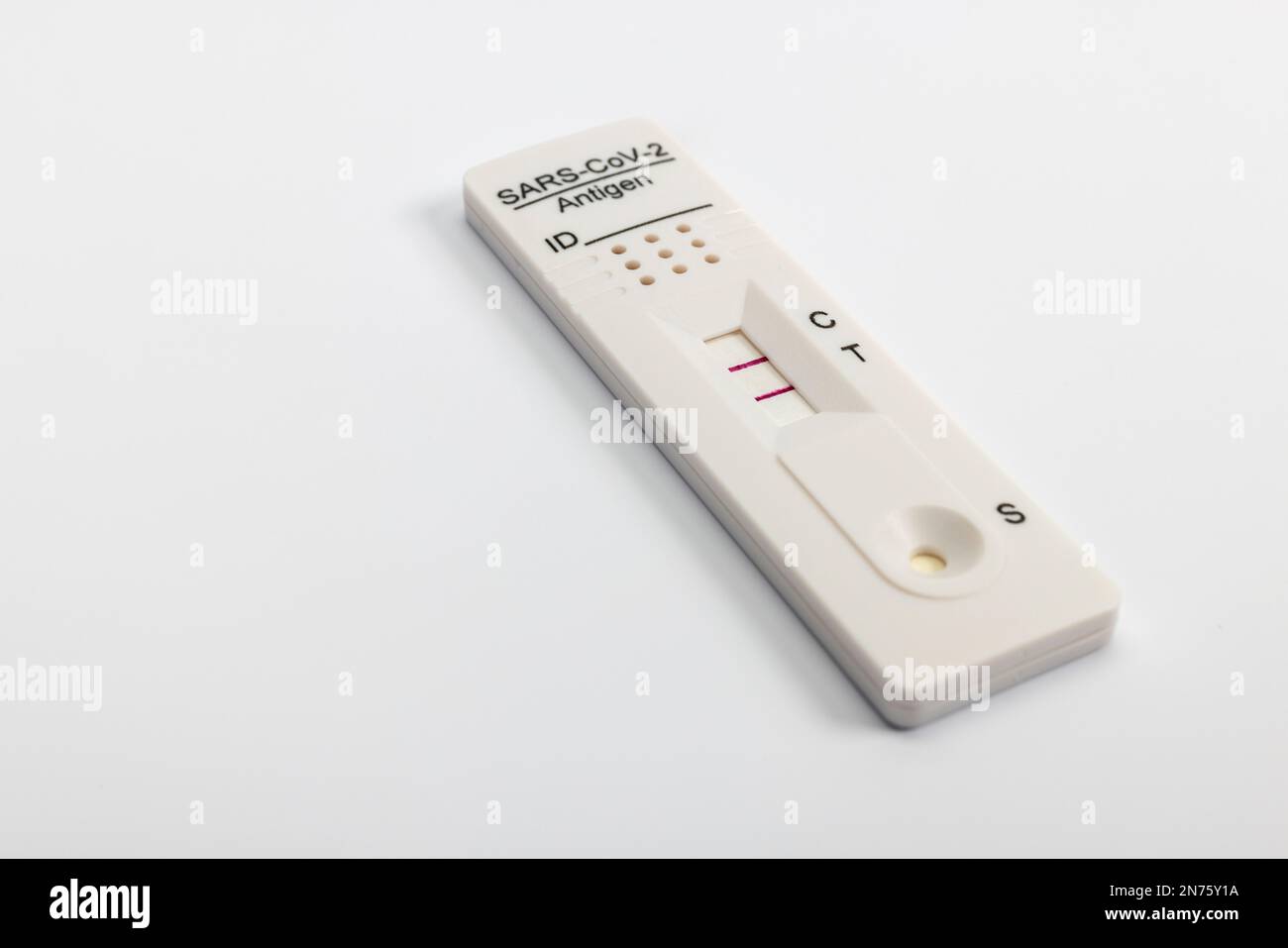 Rapid SARS-CoV-2 Antigen Test Cassette with positive test result, white ...