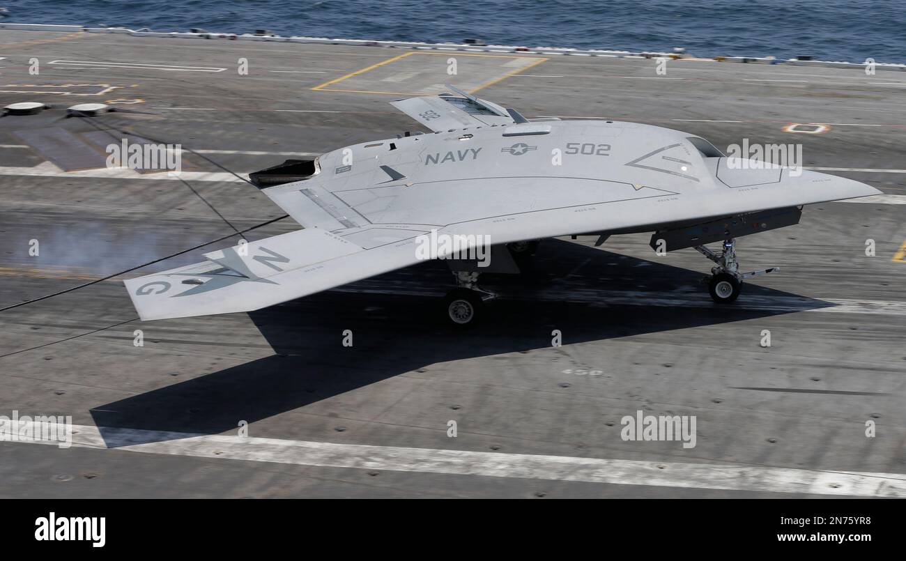 A X47-B navy drone grabs the wire as it lands aboard the nuclear ...