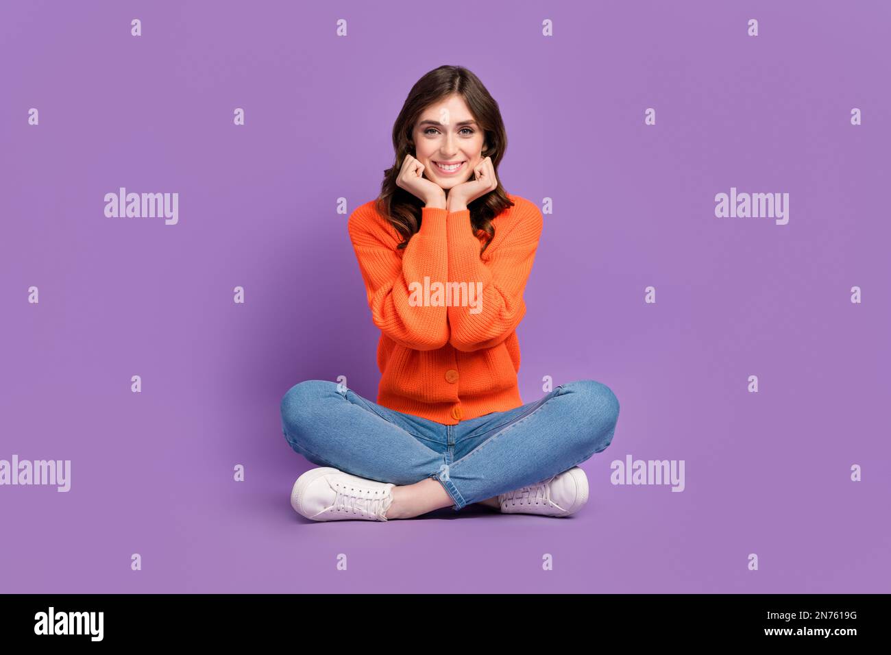 Full length photo of shiny dreamy woman dressed orange sitting floor ...
