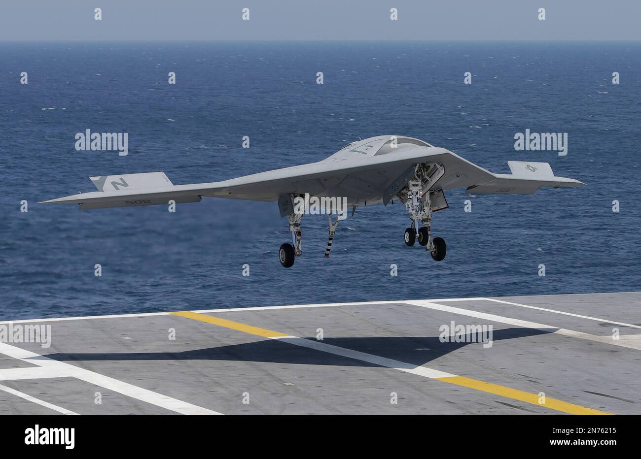 A X47-B Navy drone approaches the deck as it lands aboard the nuclear ...