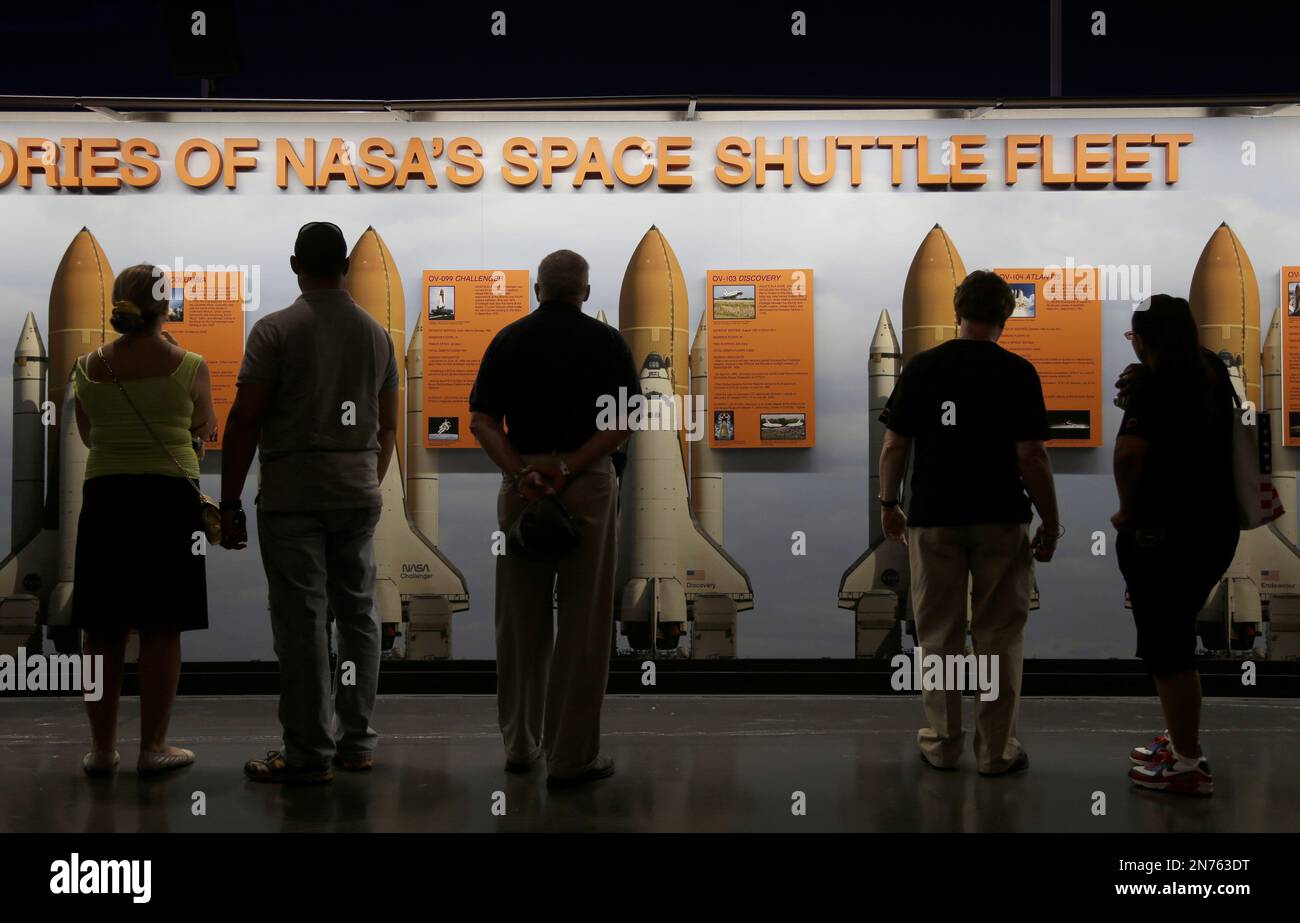 Visitors look at displays in the newly completed pavilion that houses ...