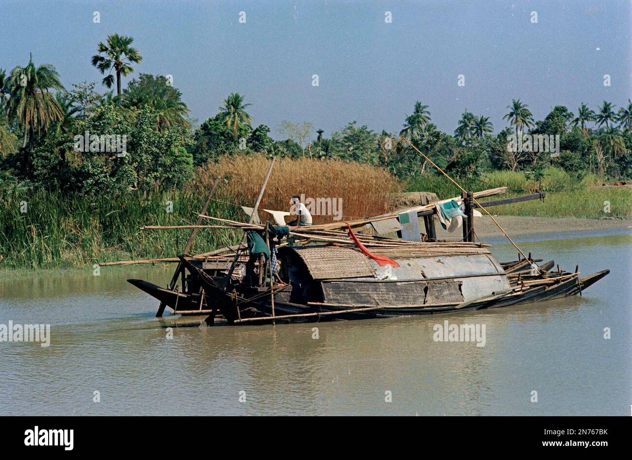 People of Bhola fish near what remains of their homes following the ...