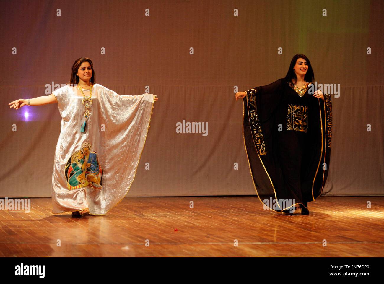 Dancers wearing traditional Iraqi folk costumes perform during a ...