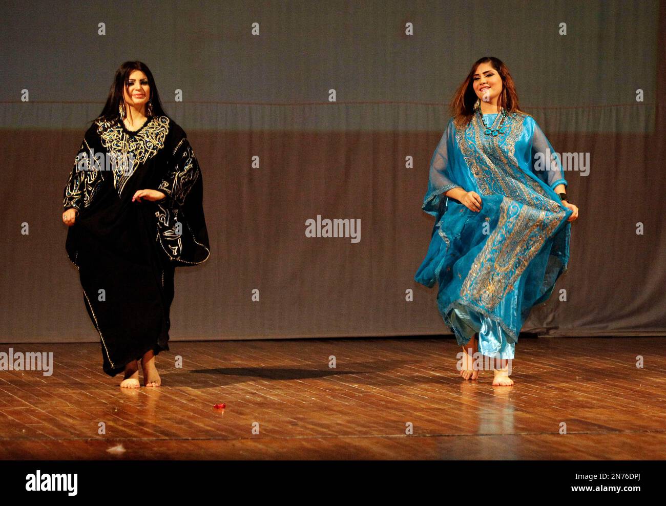 Dancers wearing traditional Iraqi folk costumes perform during a ...