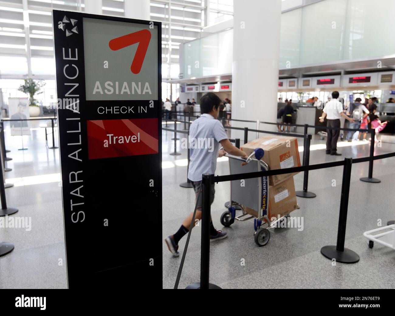 CORRECTS WRONG CAPTION - Passengers check in at the Asiana Airlines ...