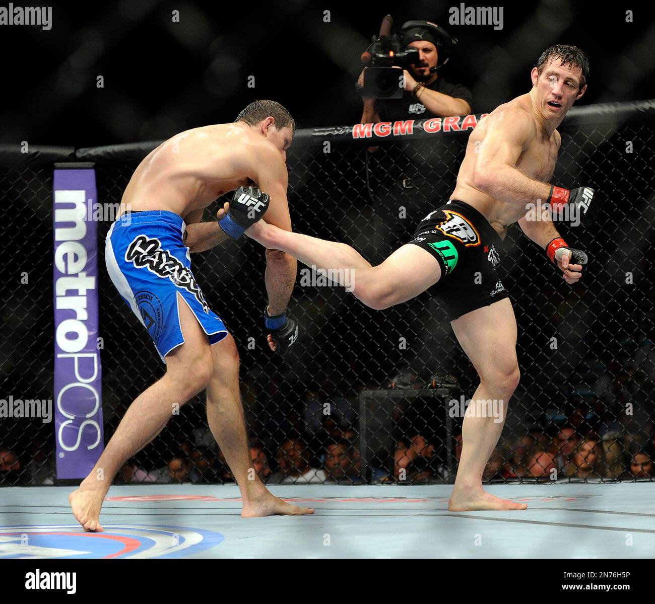 Tim Kennedy connects with a kick on Roger Gracie during their UFC 162 ...