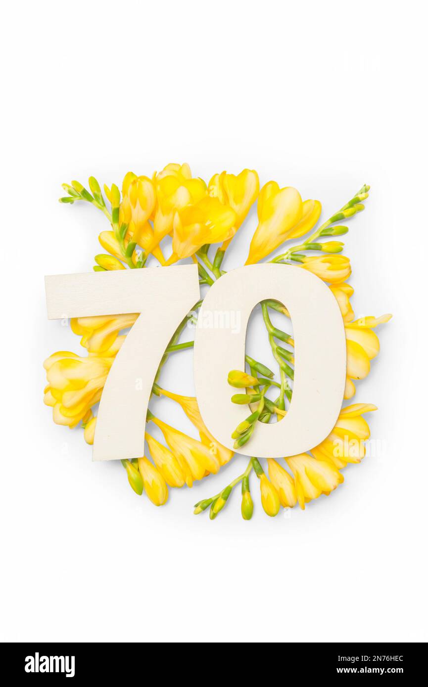 Number seventy shape with brunch of yellow freesia flower isolated over ...