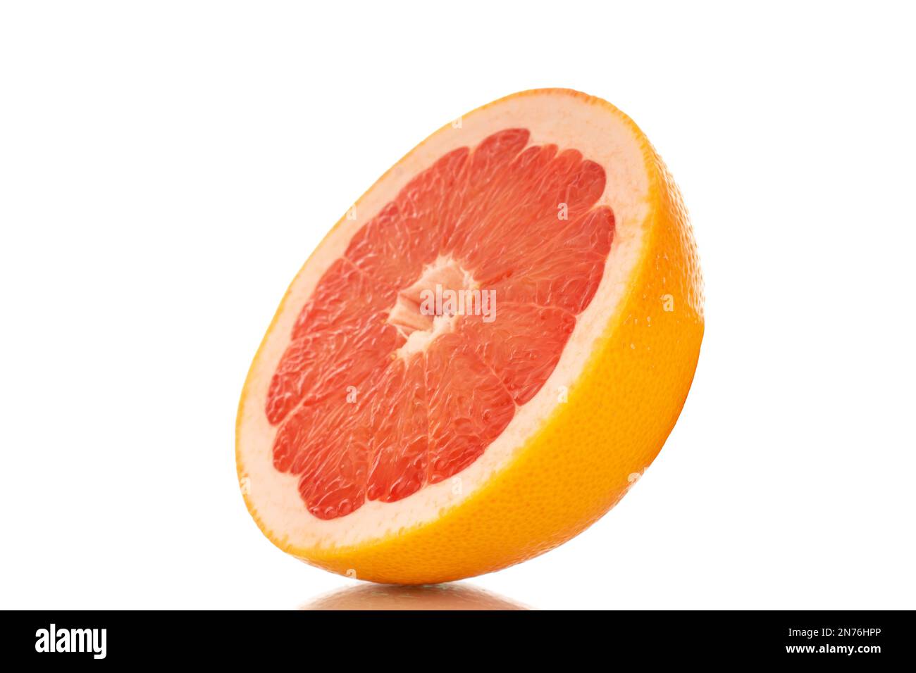 One half of a ripe grapefruit, macro, isolated on white background ...