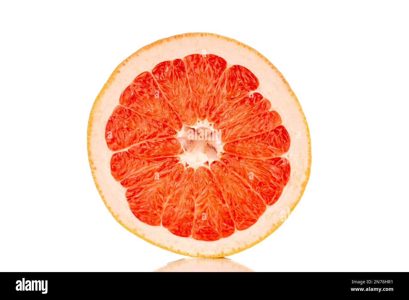 One half of a ripe grapefruit, macro, isolated on white background ...