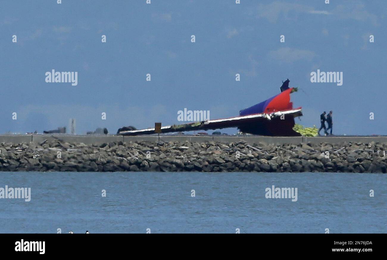 The tail of Asiana Flight 214 is seen after it crashed at San Francisco ...