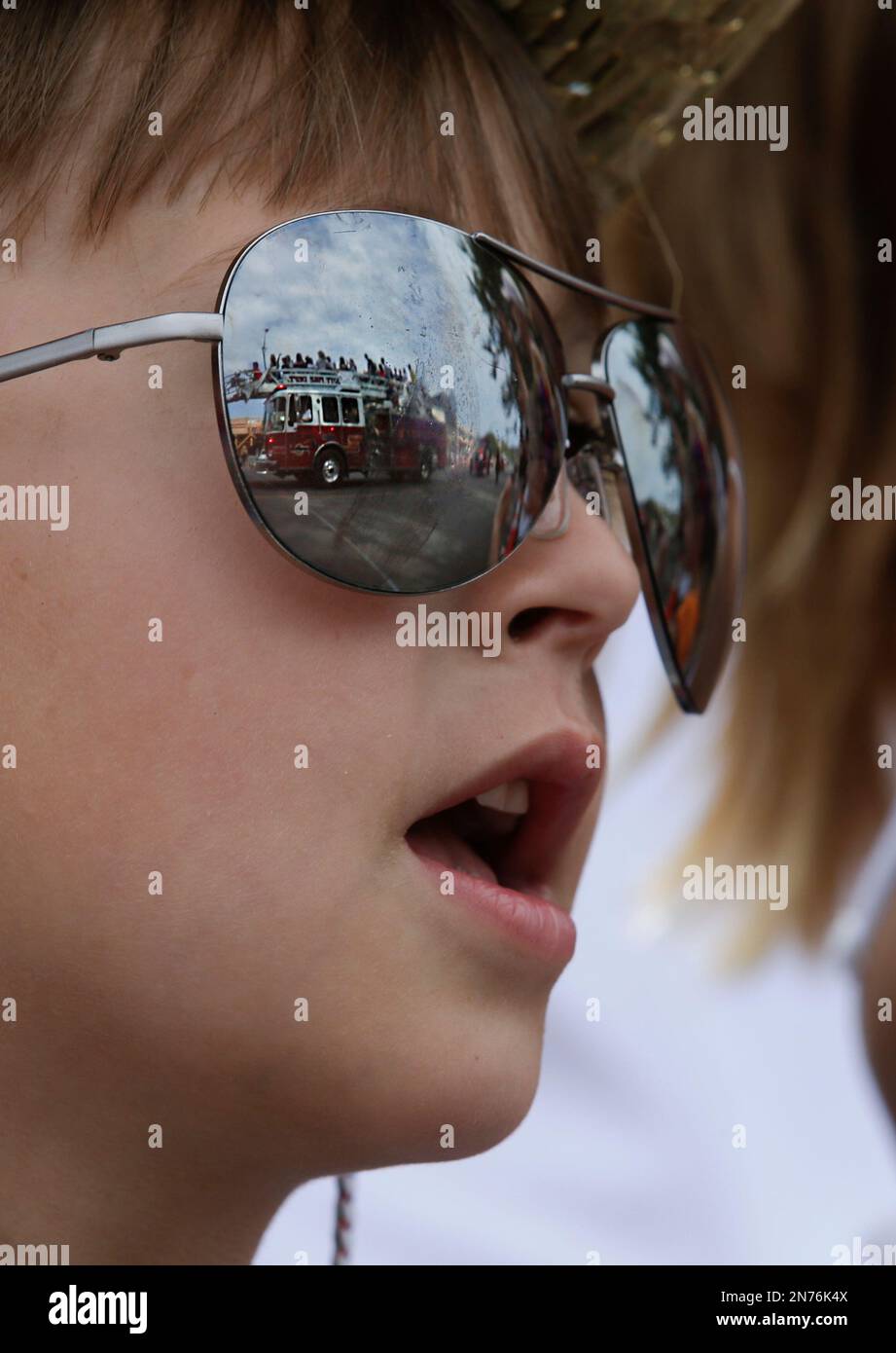 Logan Magallanez, 5, watches as a fire truck carrying friends and ...