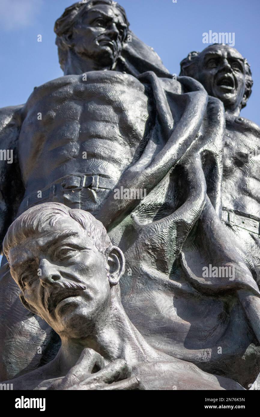 A low-angle view of the statue of three men under the blue sky Stock ...
