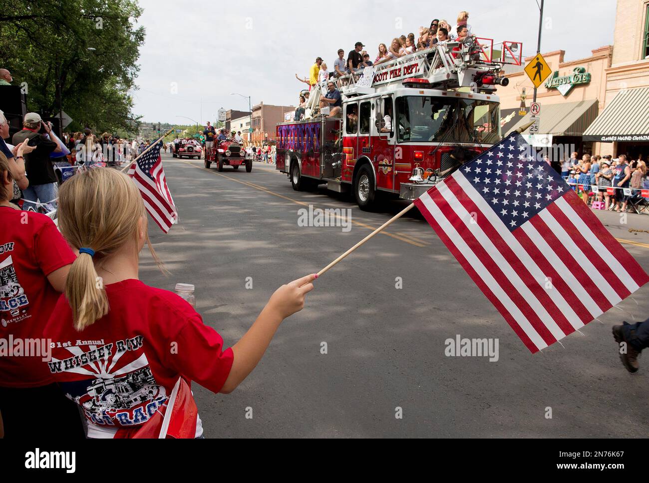 Spectators stand as a Prescott Fire Department engine, carrying family ...
